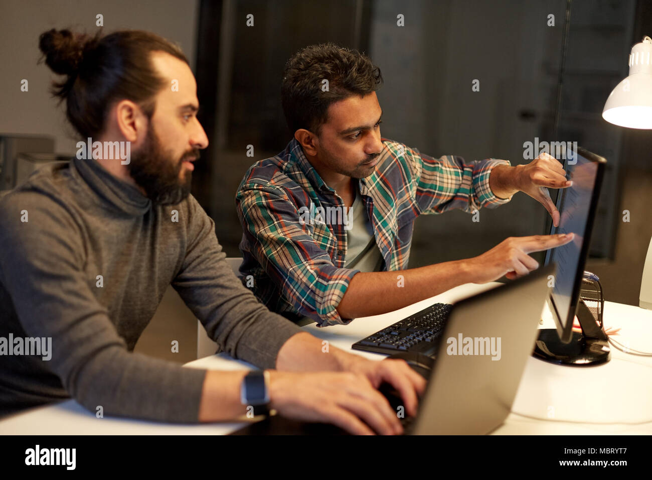 creative team with computer working late at office Stock Photo - Alamy