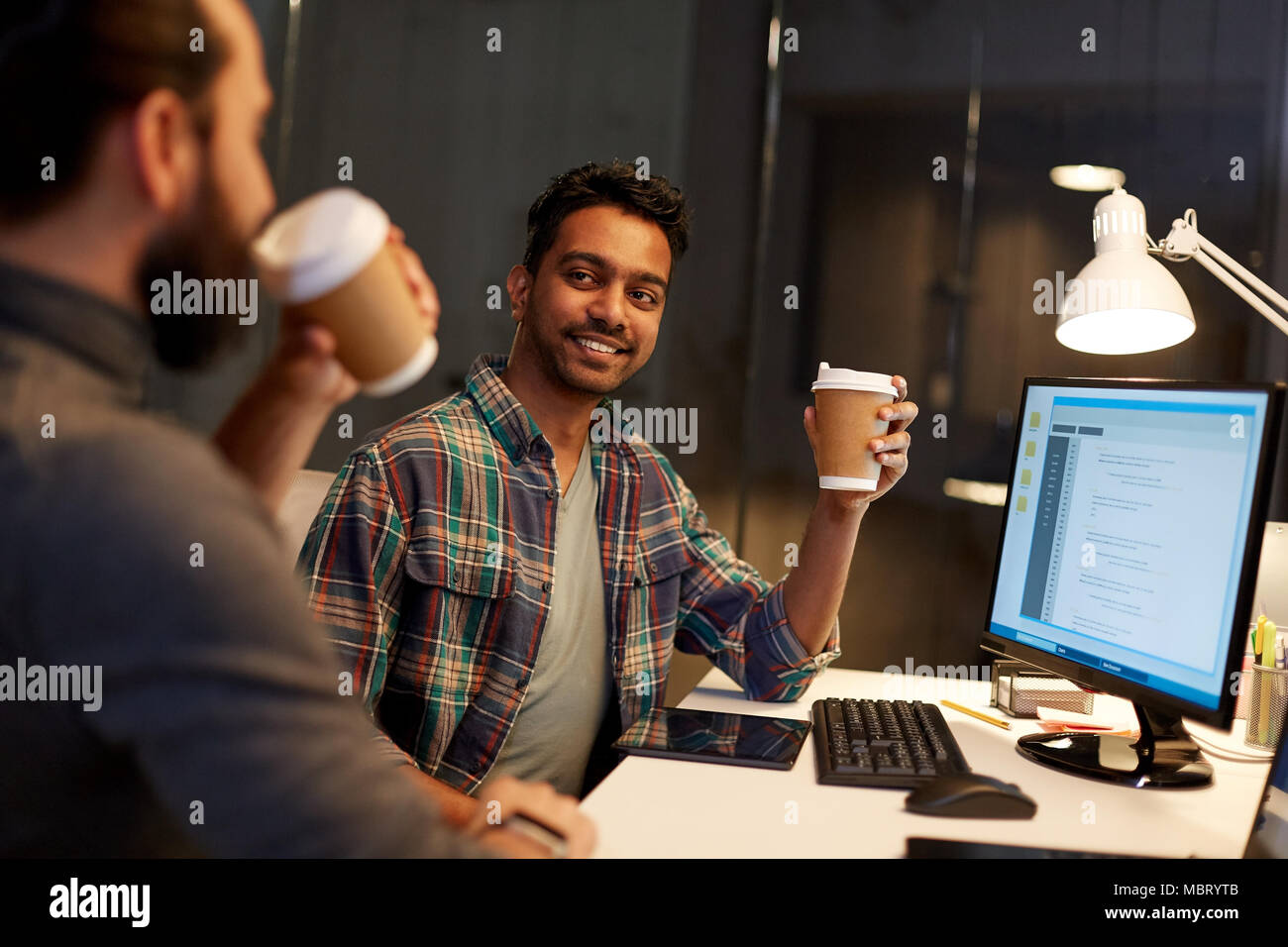 creative team drinking coffee at night office Stock Photo - Alamy