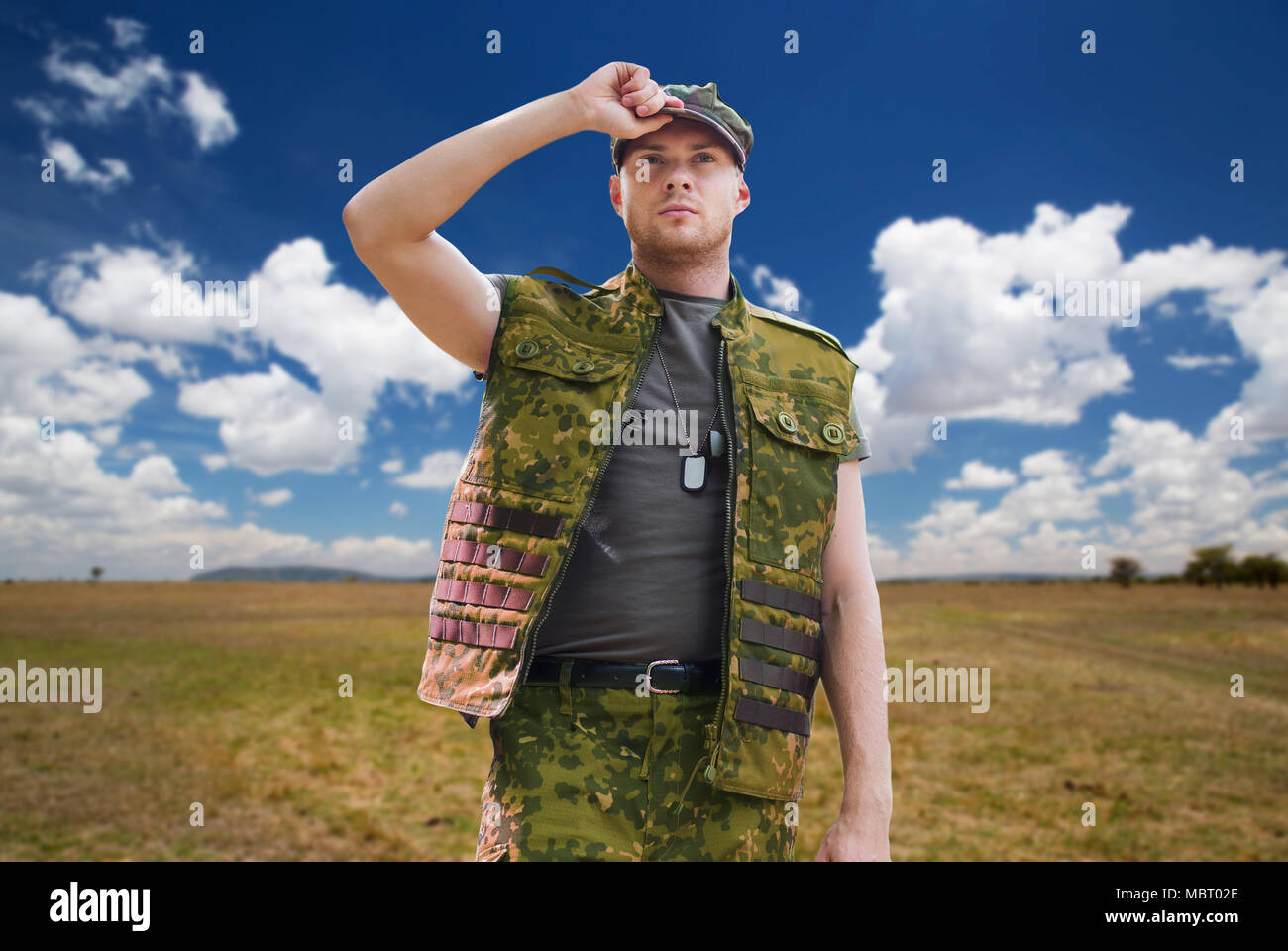 soldier in military uniform over sky background Stock Photo - Alamy
