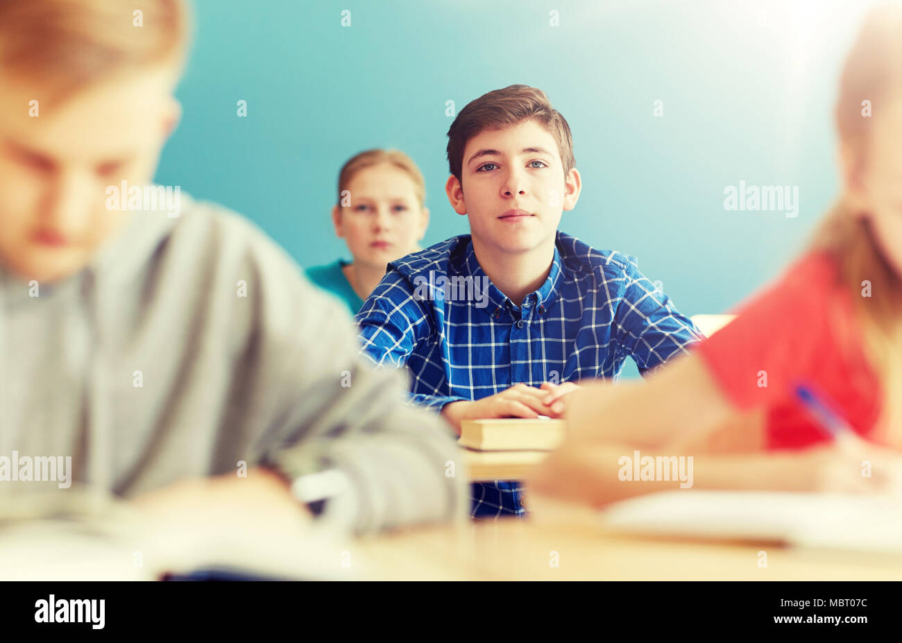 group of students with notebooks at school lesson Stock Photo - Alamy
