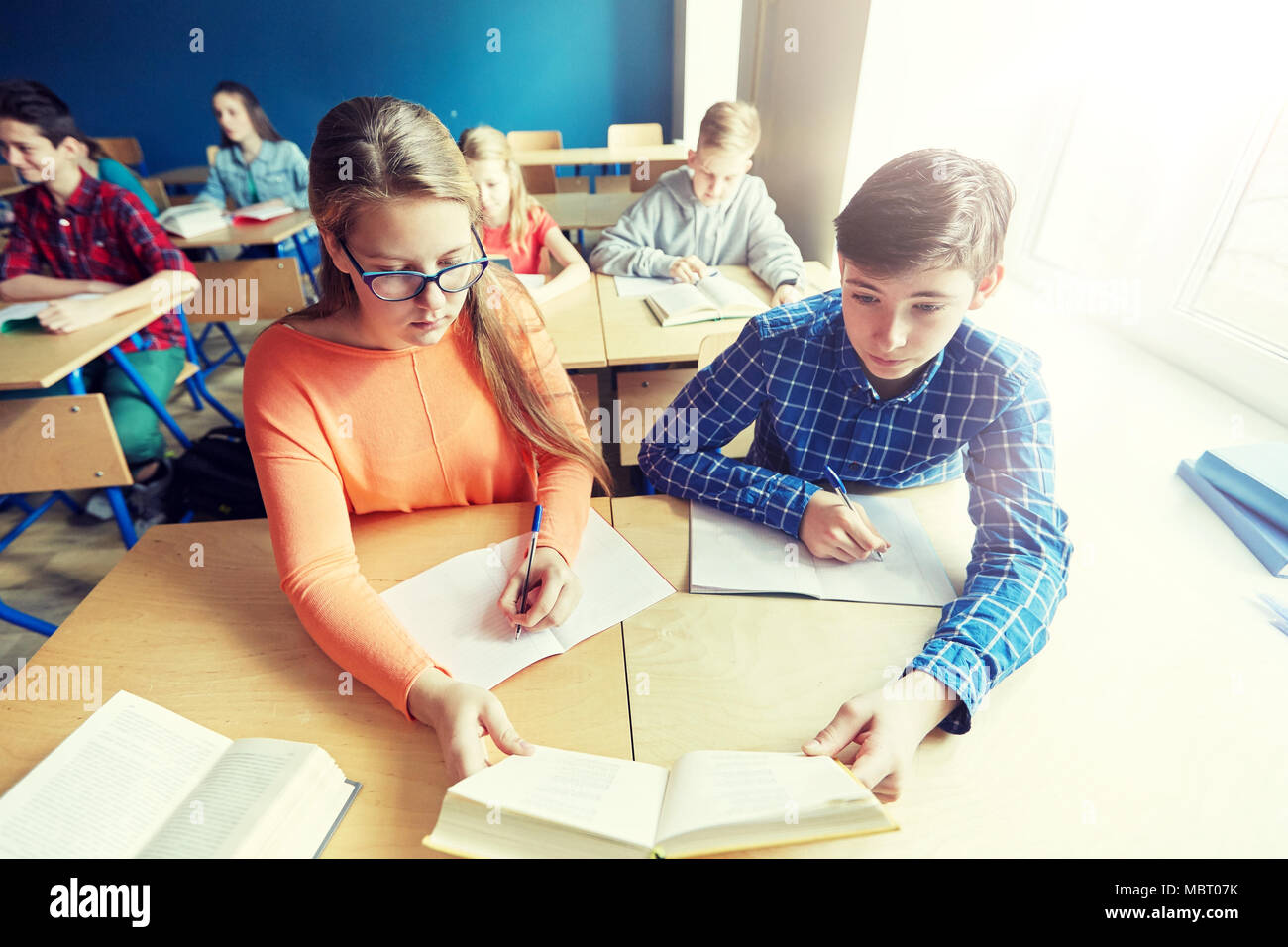 students reading book at school lesson Stock Photo - Alamy