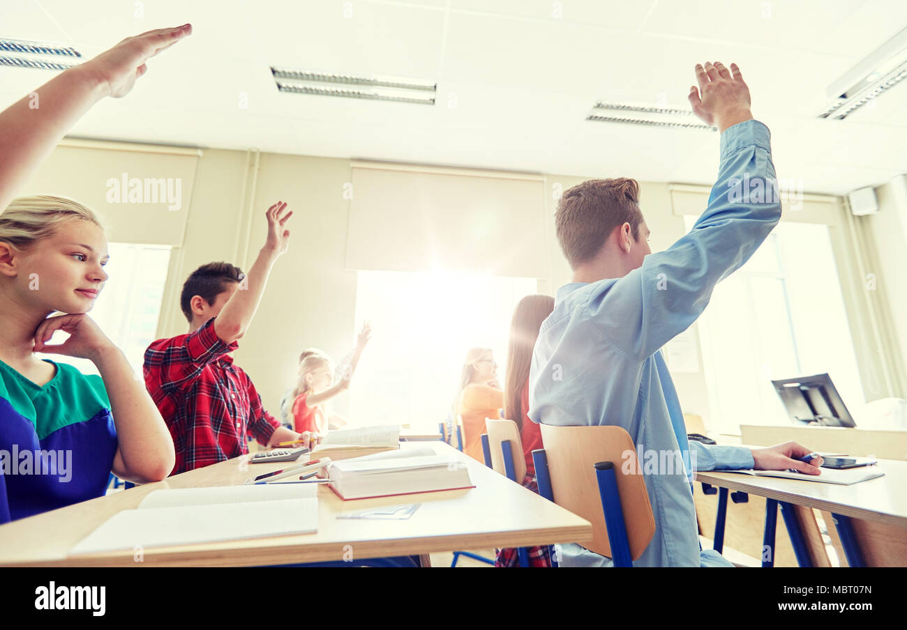 group of students with raised hands at high school Stock Photo - Alamy