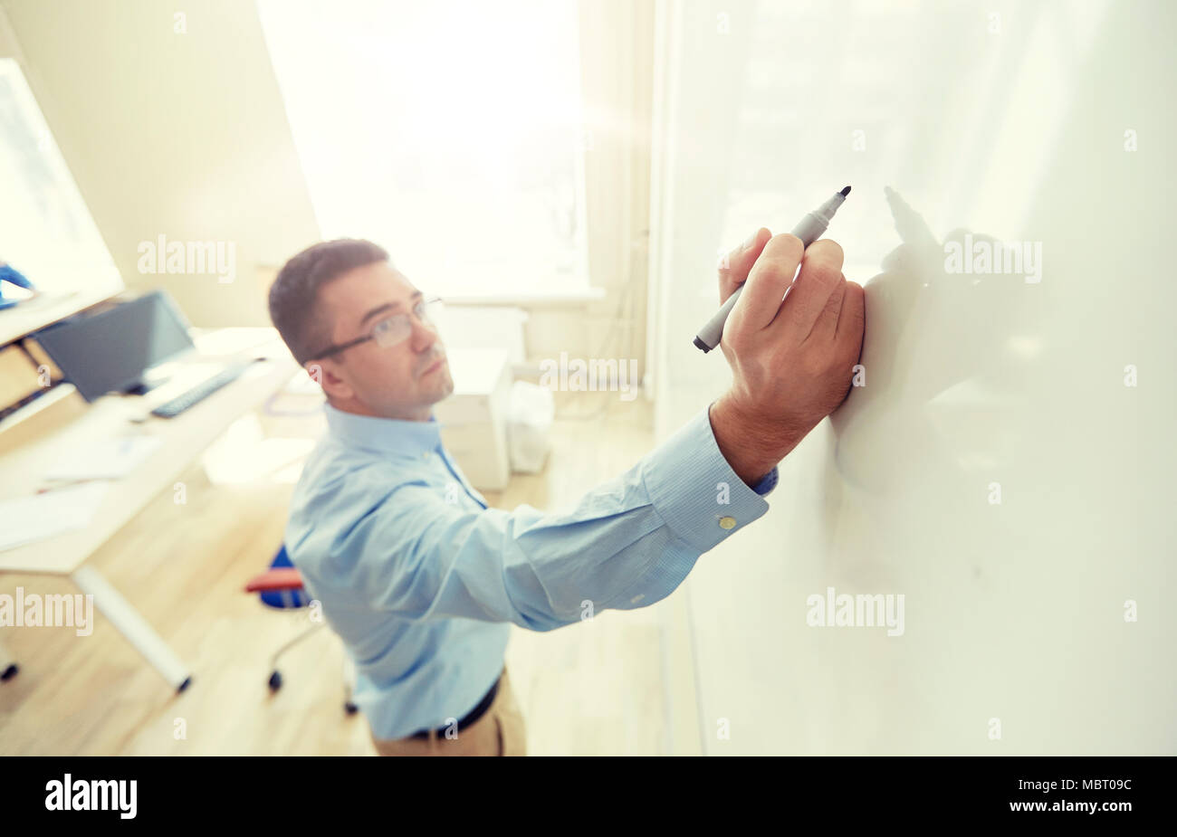 teacher writing on school white board Stock Photo - Alamy