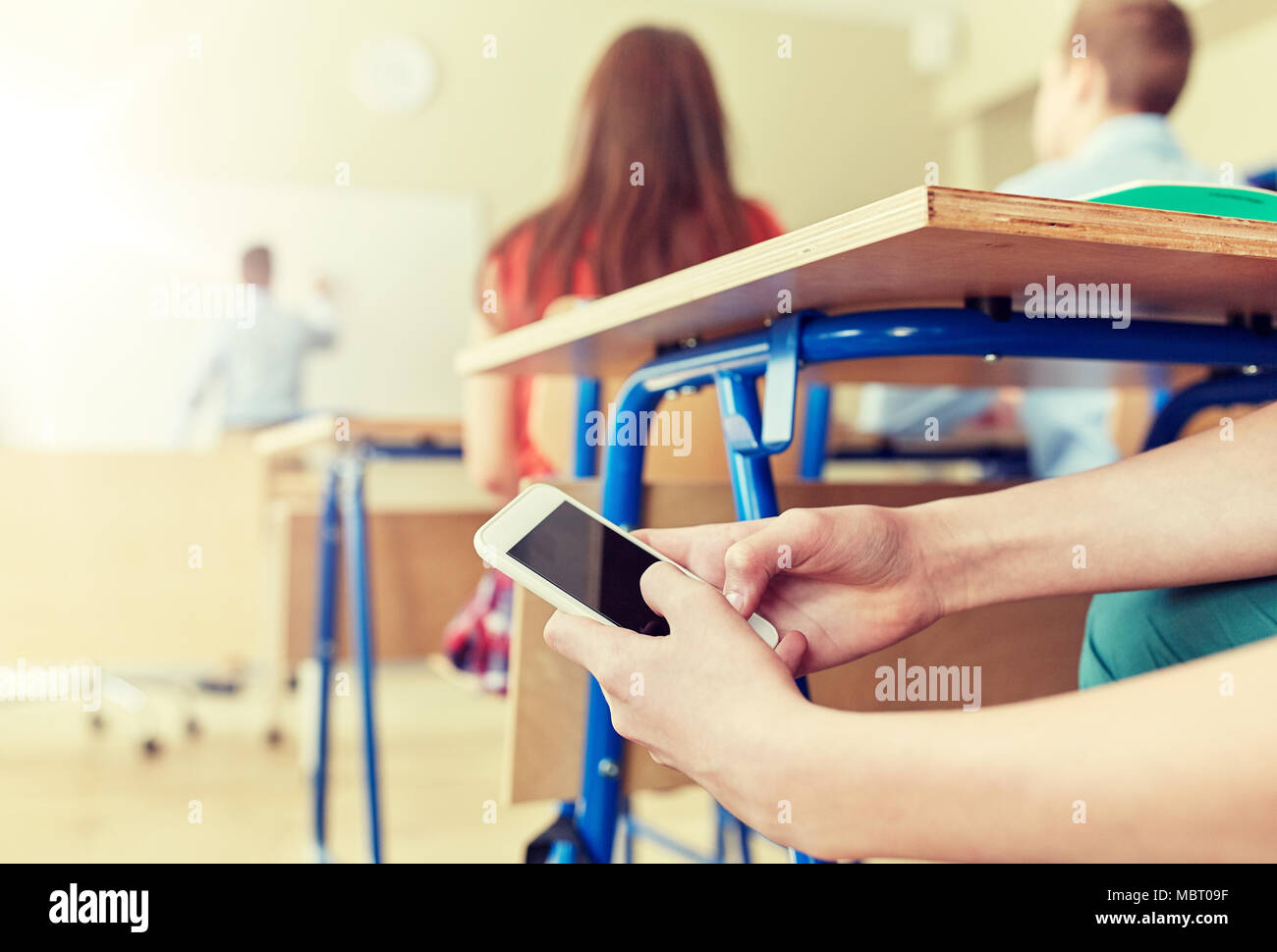 student boy with smartphone texting at school Stock Photo - Alamy
