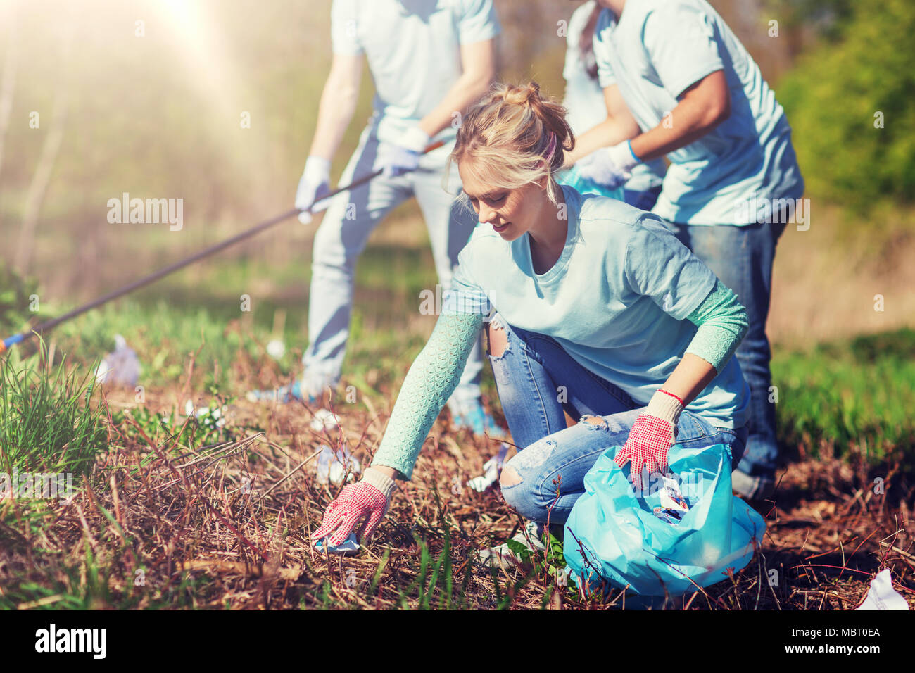 volunteers with garbage bags cleaning park area Stock Photo - Alamy