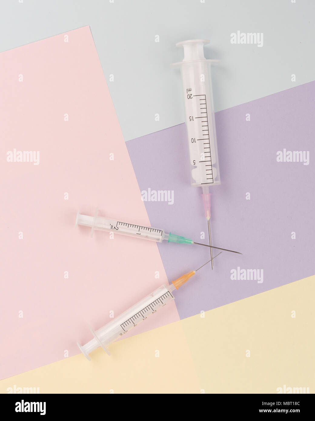 syringe on a colored background Stock Photo - Alamy
