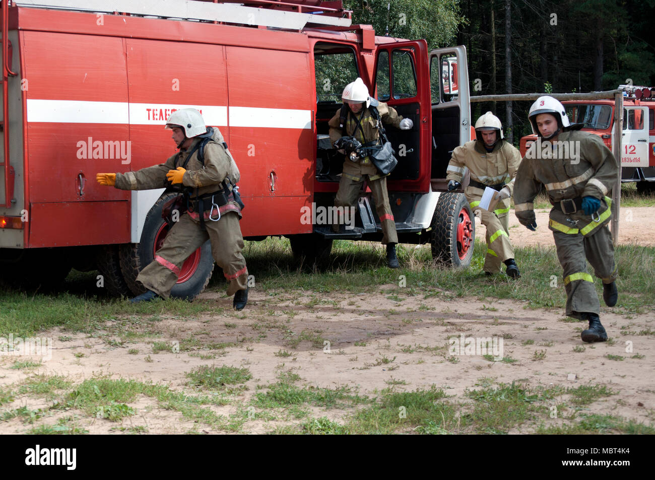 Yartsevo, Russia - August 26, 2011: Firefighters jump out and run from ...