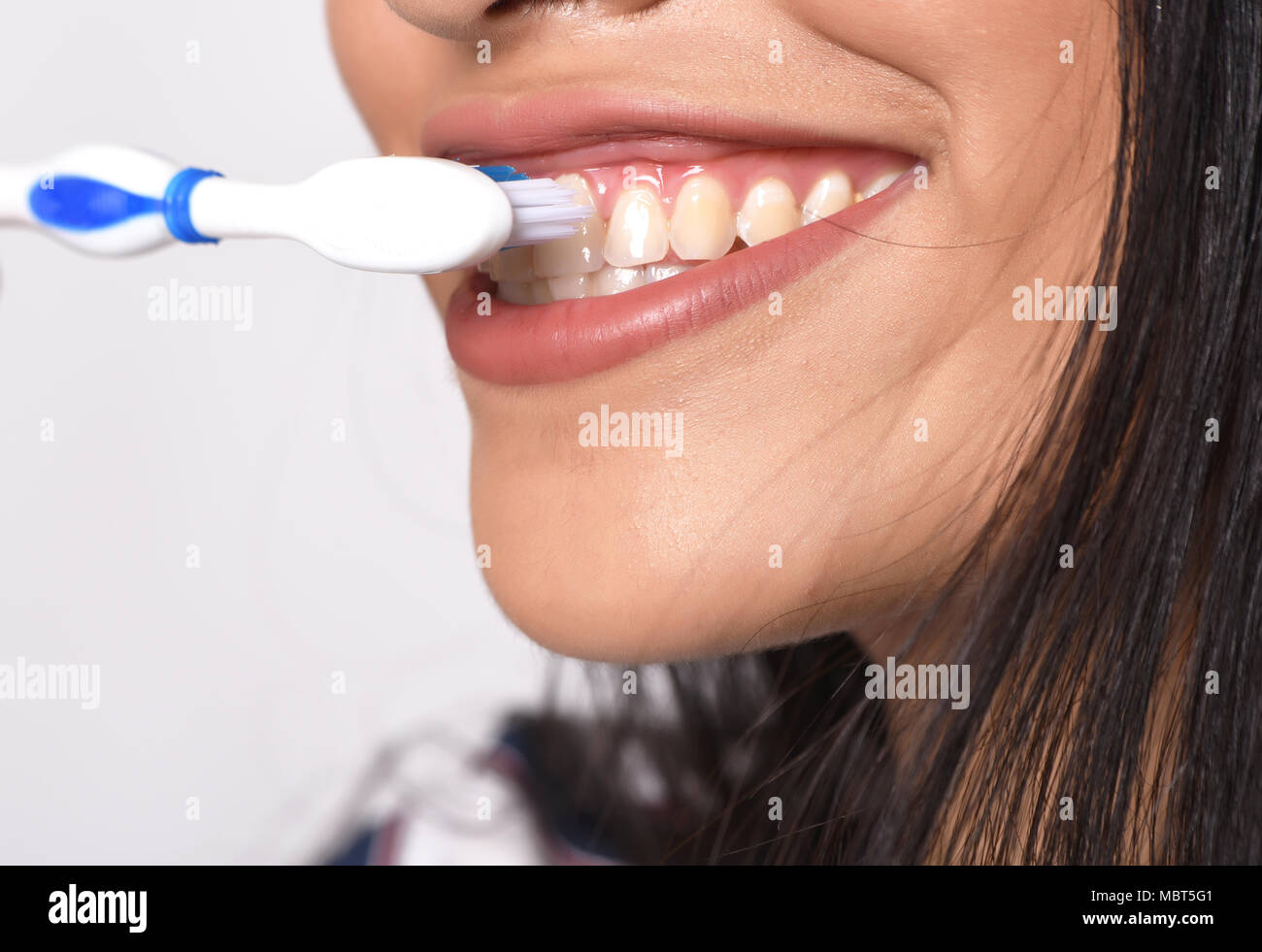 Close-up woman brushing her teeth. Isolated white background Stock ...