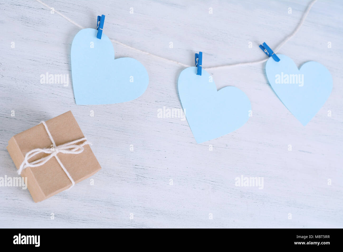 Dad message written on hearts hanging on clothespins on white wooden ...