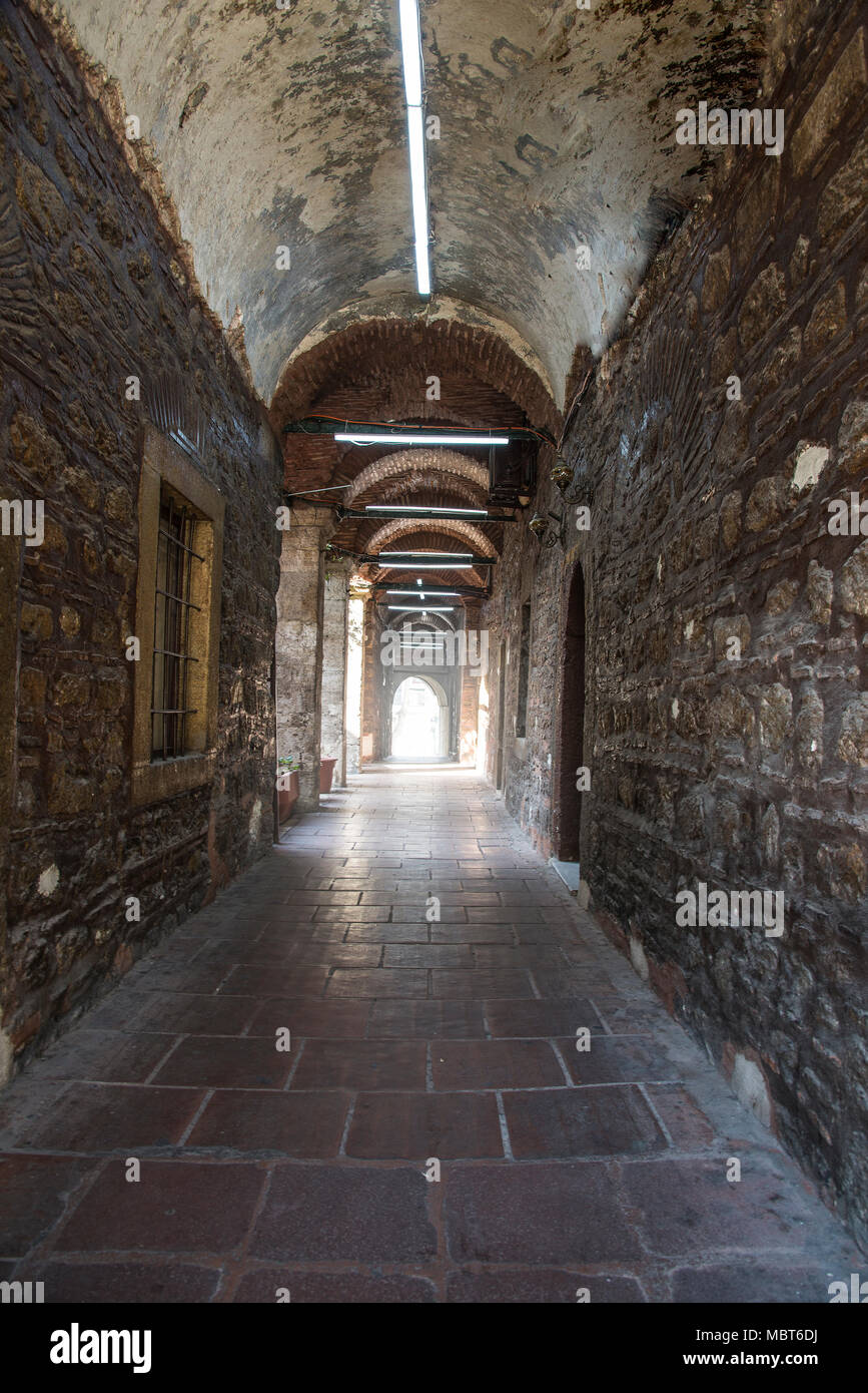 Old stone corridor with the door at the end Stock Photo - Alamy