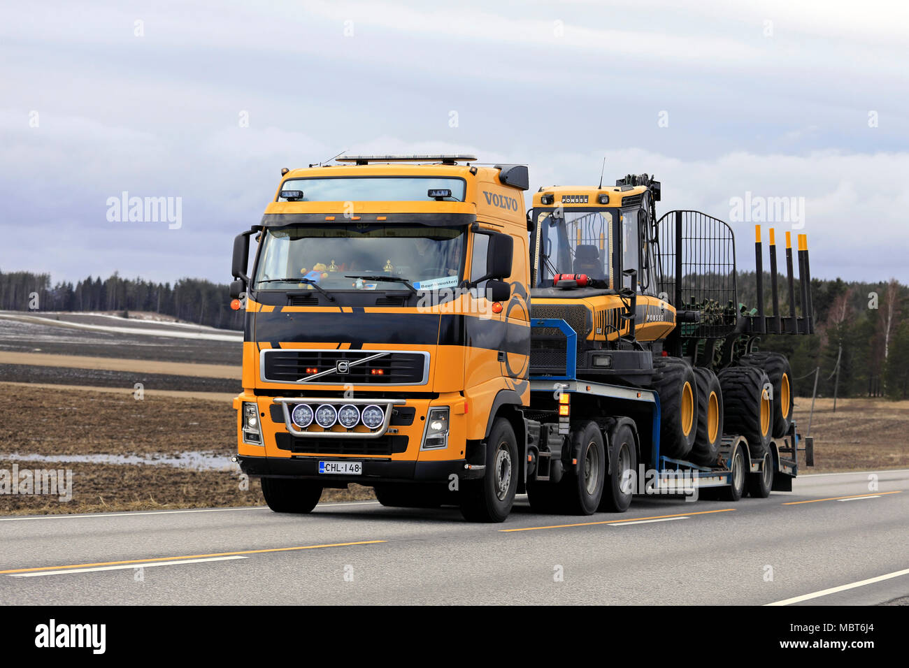 SALO, FINLAND - APRIL 6, 2018: Yellow Volvo FH semi transports Ponsse ...