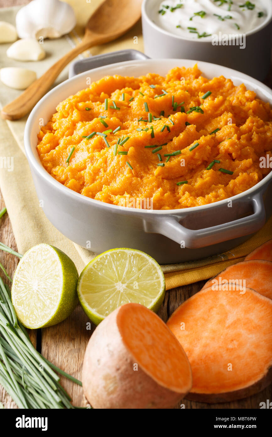 Delicious puree of sweet potato with garlic and onion close-up in a ...