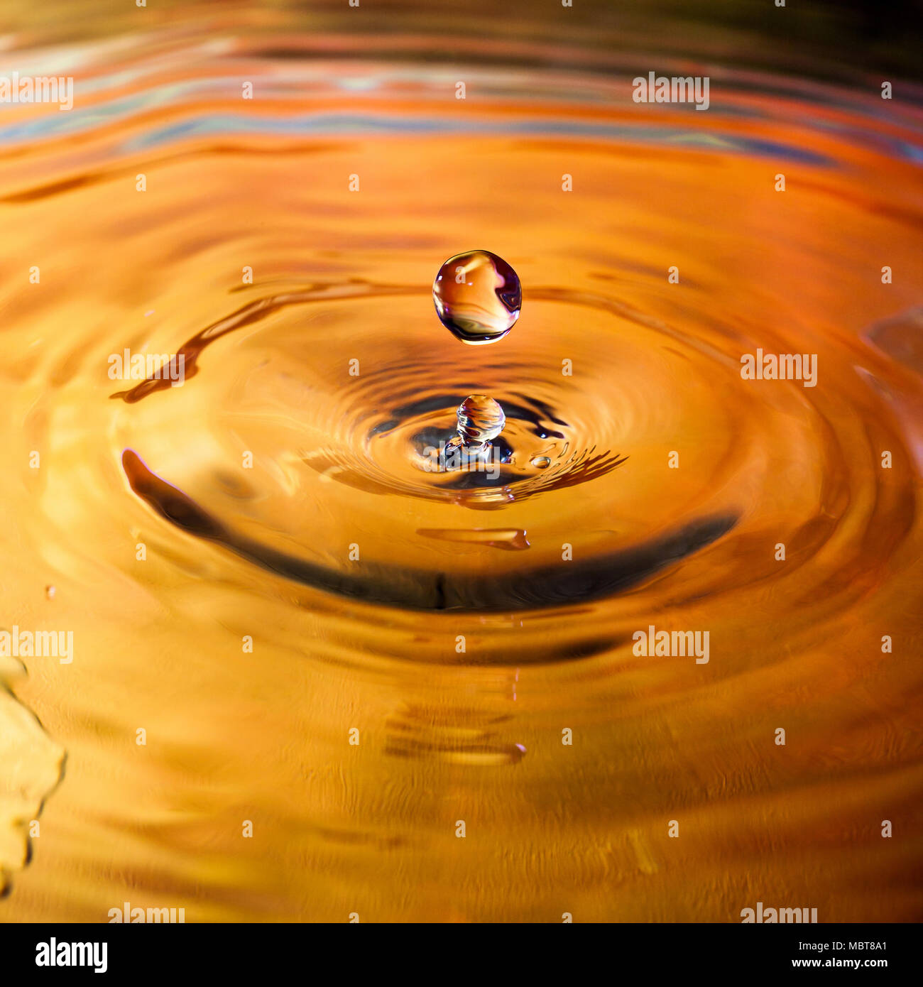 Colorful water drop splash in water macrophotography Stock Photo - Alamy