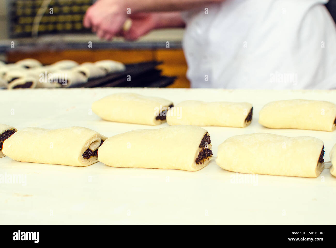 Working on a sweet pastry in a big industrial bakery Stock Photo - Alamy