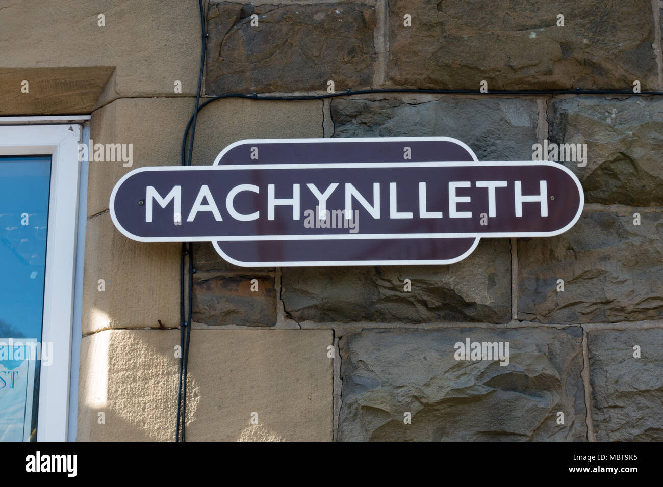 Sign on Station wall at Machynlleth Railway Station. Powys. Wales Stock ...