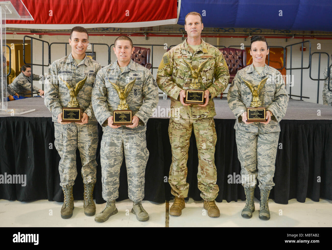 Airmen of the 147th Attack Wing hold their awards after being named the ...