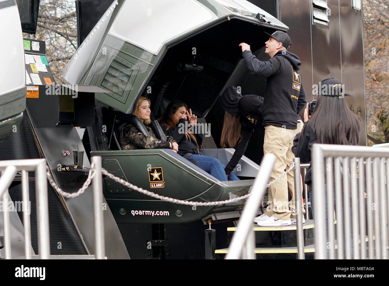 Students climb in to a flight simulator at the GoArmy Experience Zone ...