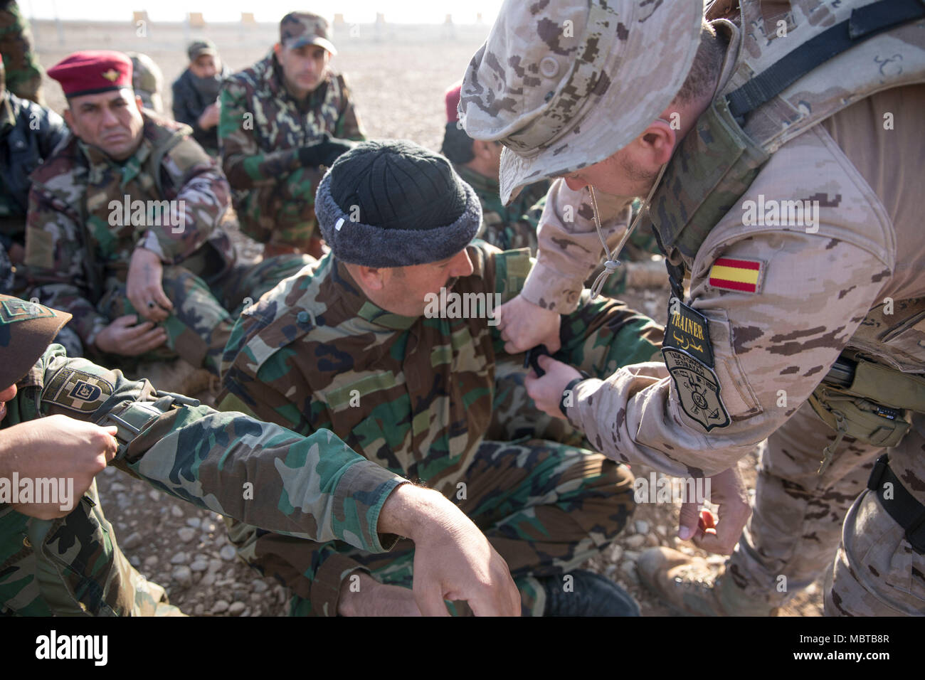 A Spanish soldier assigned to La Legion Infantry, applies a tourniquet ...