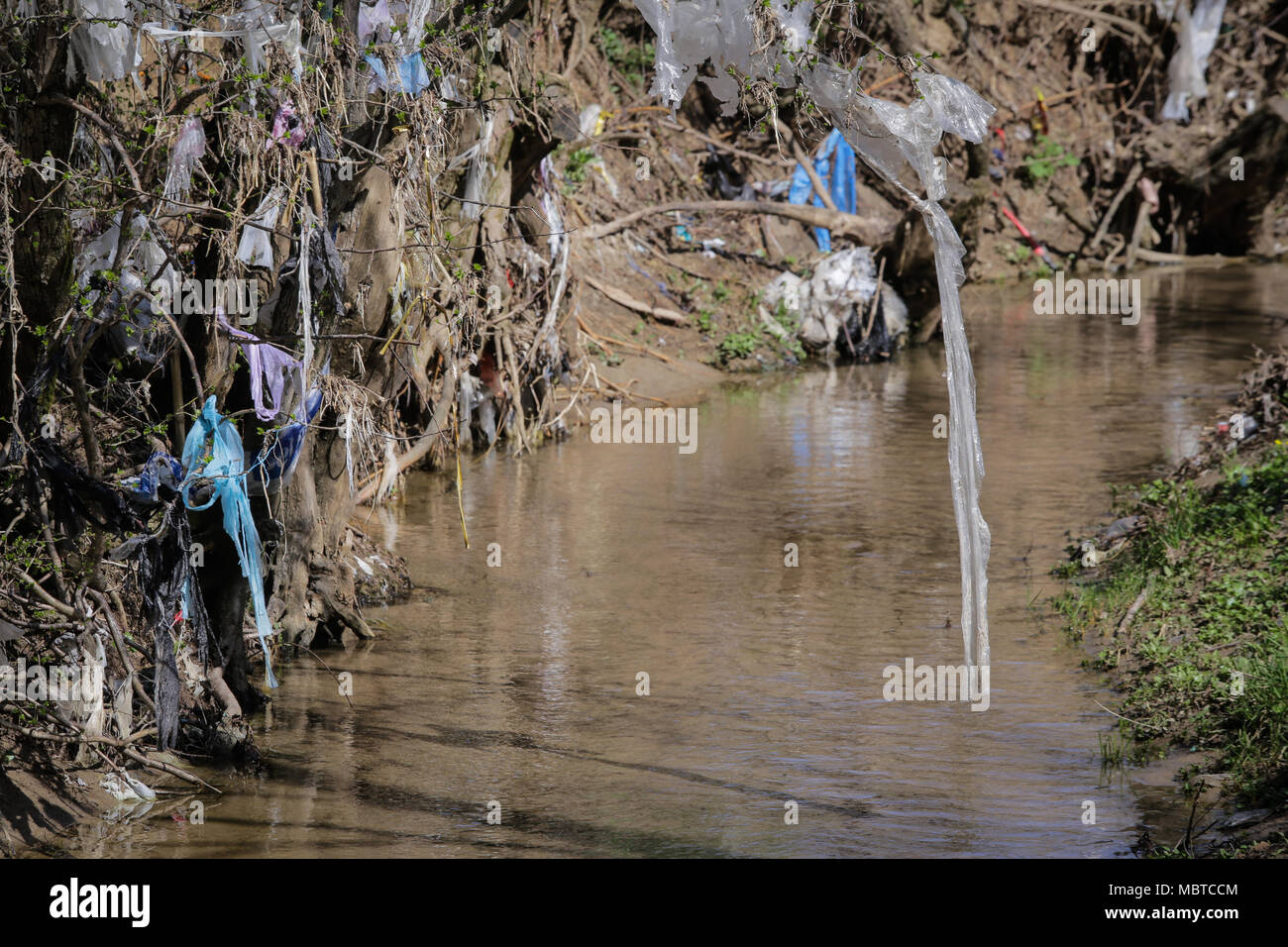 Heavy polluted water stream with domestic garbage Stock Photo - Alamy