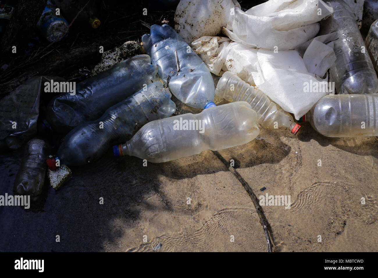 Heavy polluted water stream with domestic garbage Stock Photo - Alamy