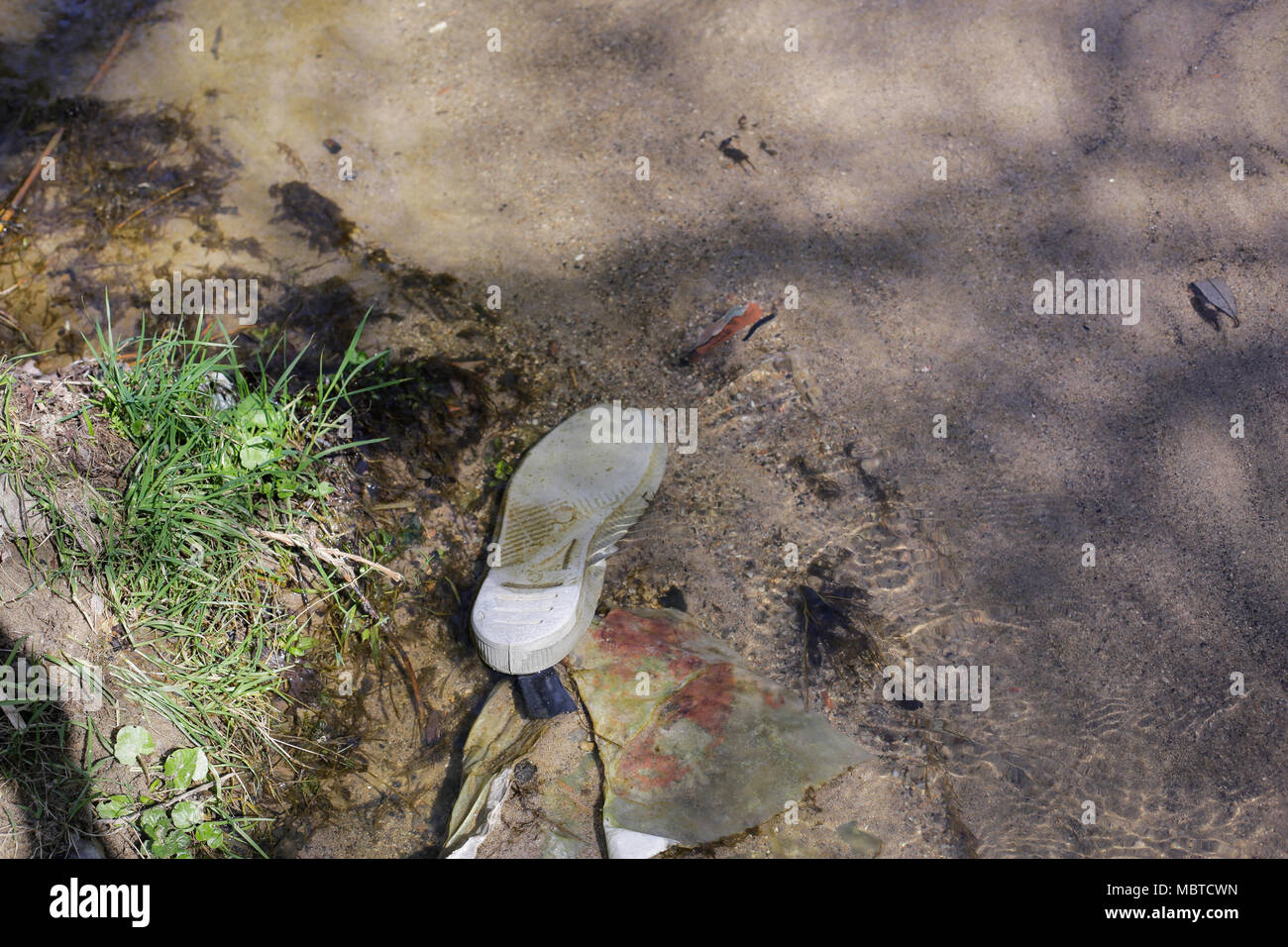 Heavy polluted water stream with domestic garbage Stock Photo - Alamy
