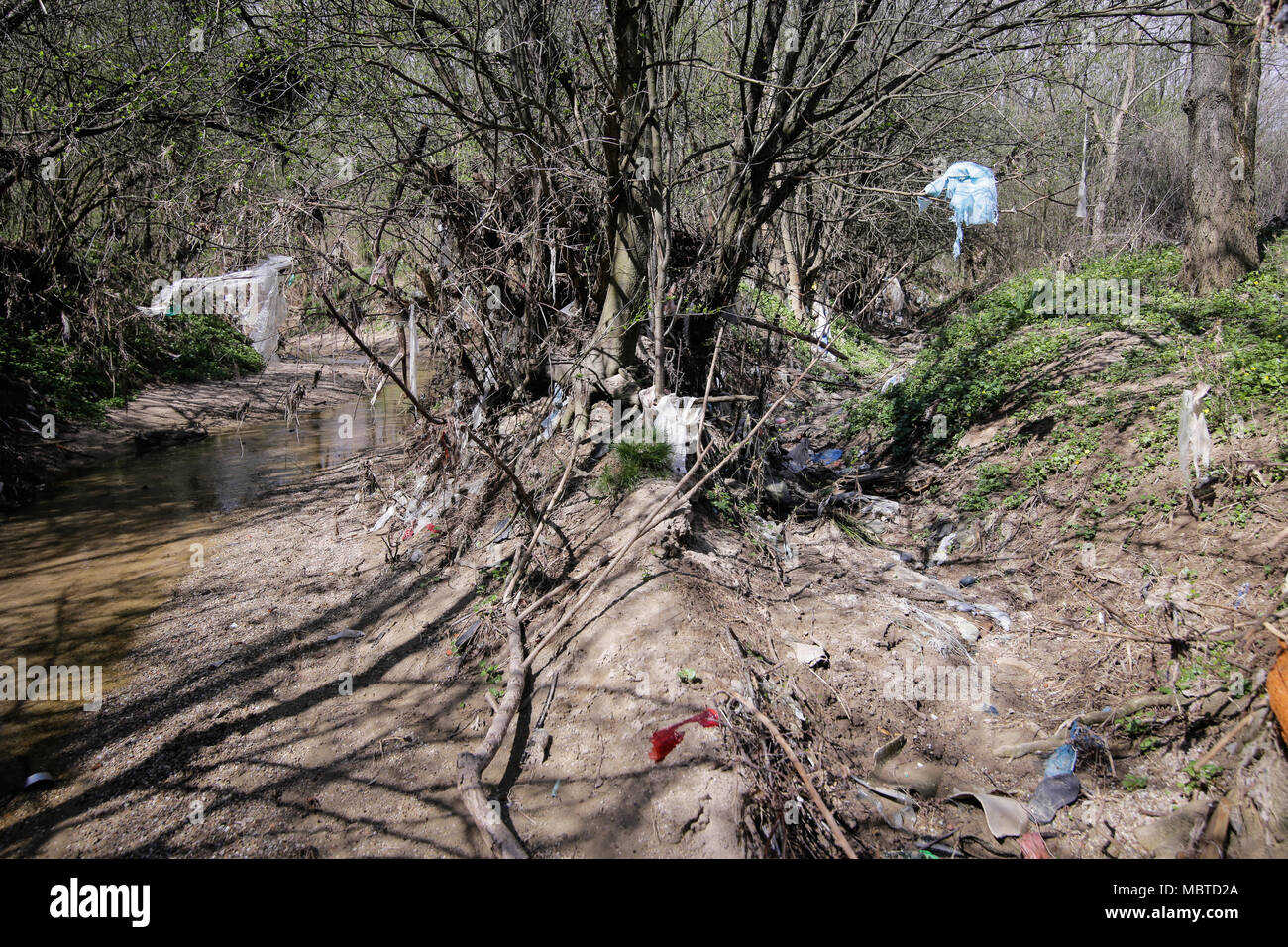 Heavy polluted water stream with domestic garbage Stock Photo - Alamy