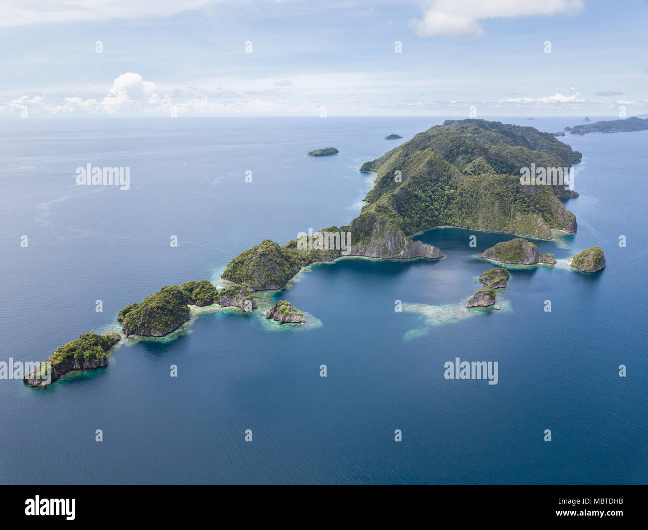Amazing limestone islands rise from the calm seascape around Misool ...