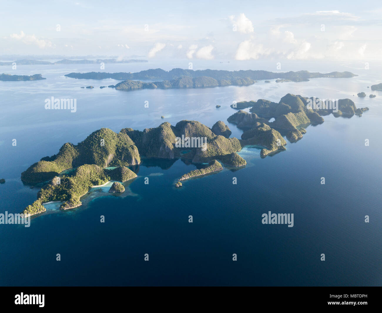 Amazing limestone islands rise from the calm seascape around Misool ...