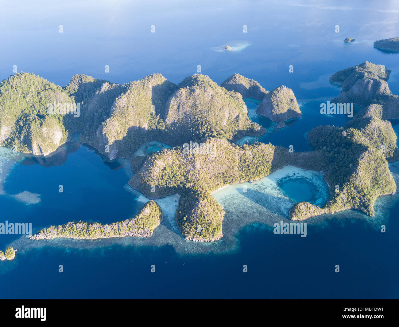 Amazing limestone islands rise from the calm seascape around Misool ...