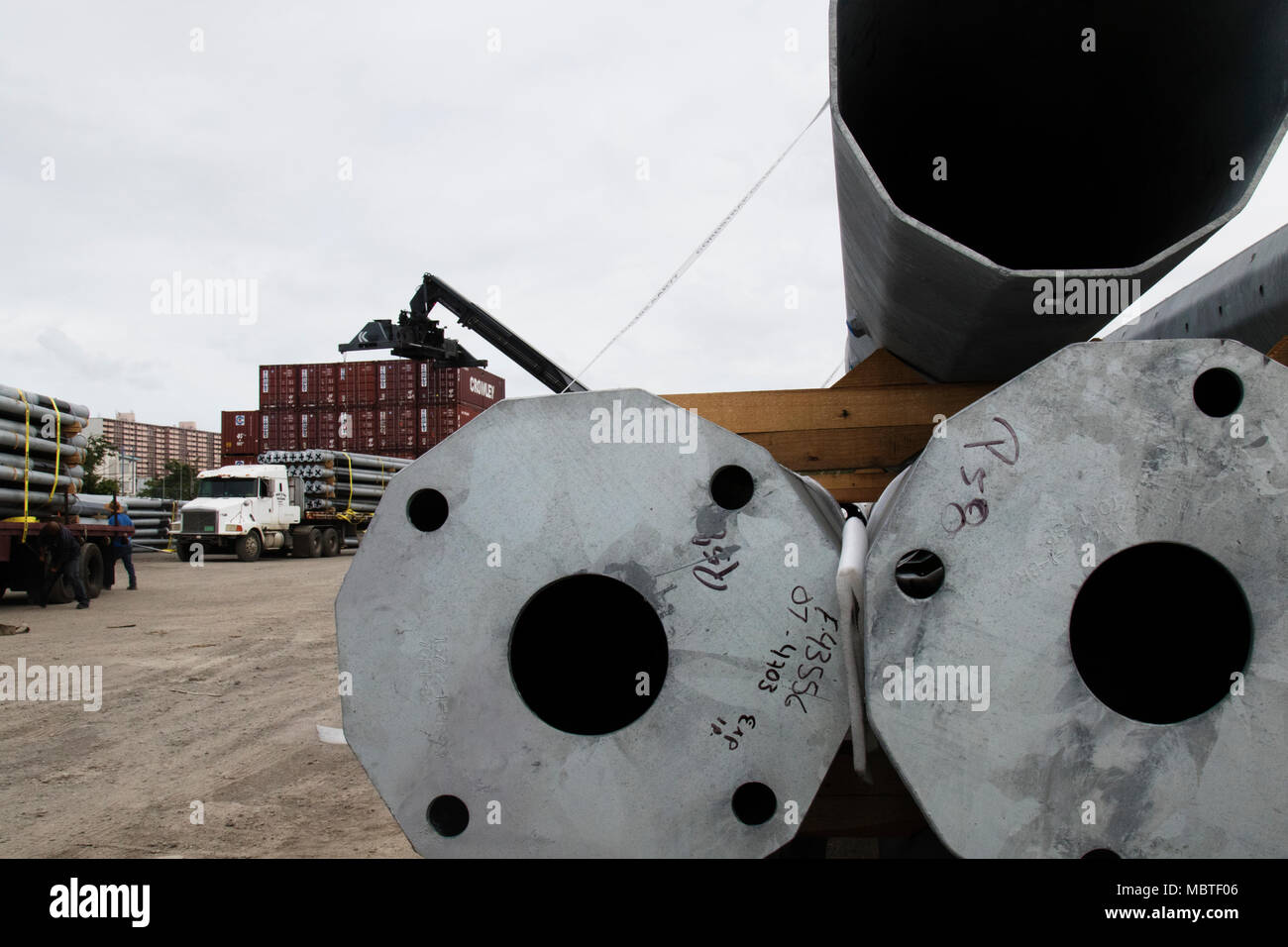 Power pole shipments are loaded onto trucks at a pier in San Juan ...