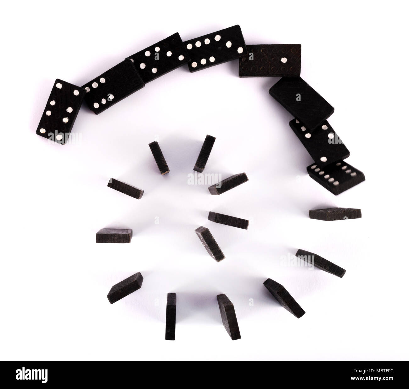 Dominoes falling in spiral shape on white background Stock Photo - Alamy