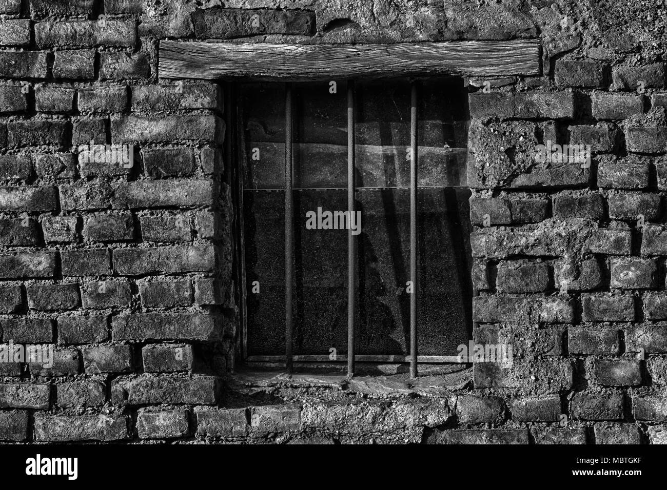 Old brick wall with brick filled window with grid Stock Photo - Alamy