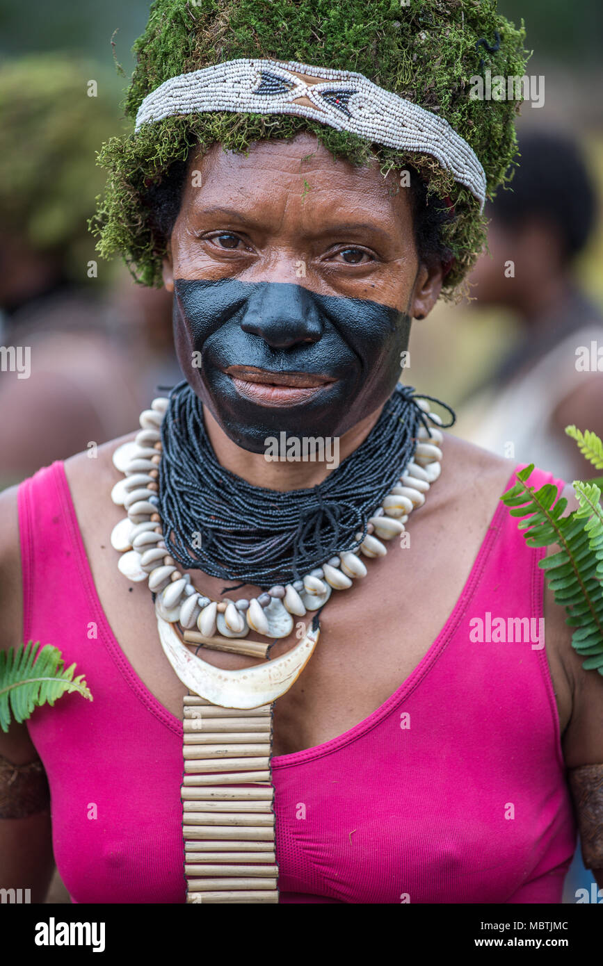 Portrait of a woman in traditional costume with her face painted ...