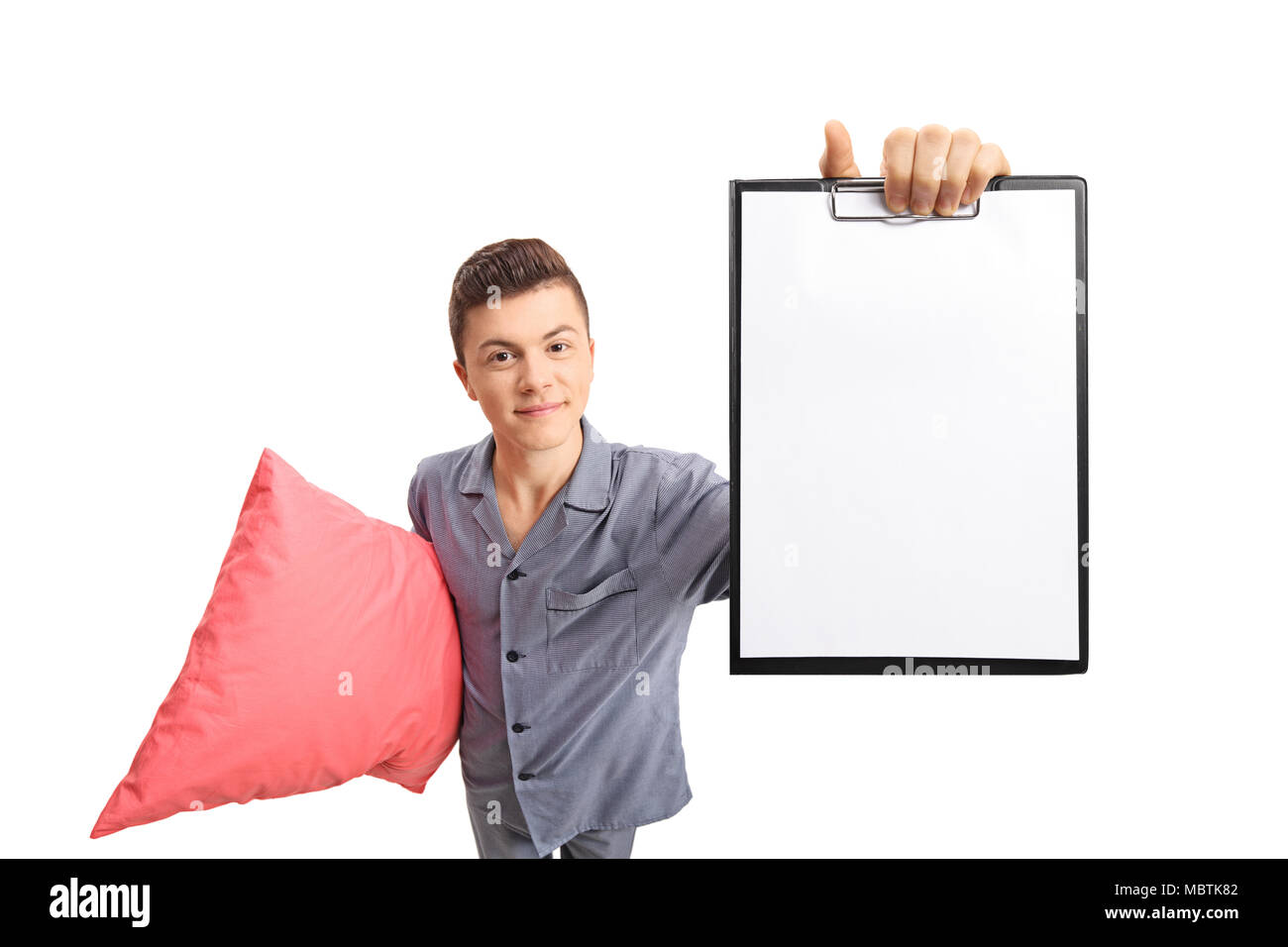 Teenage boy holding a pillow and a clipboard isolated on white ...