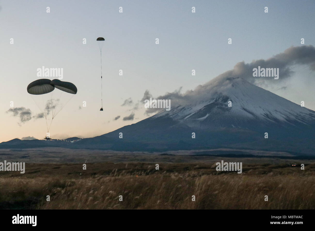 Bundles fall to the ground after being released from a C-130J Super ...