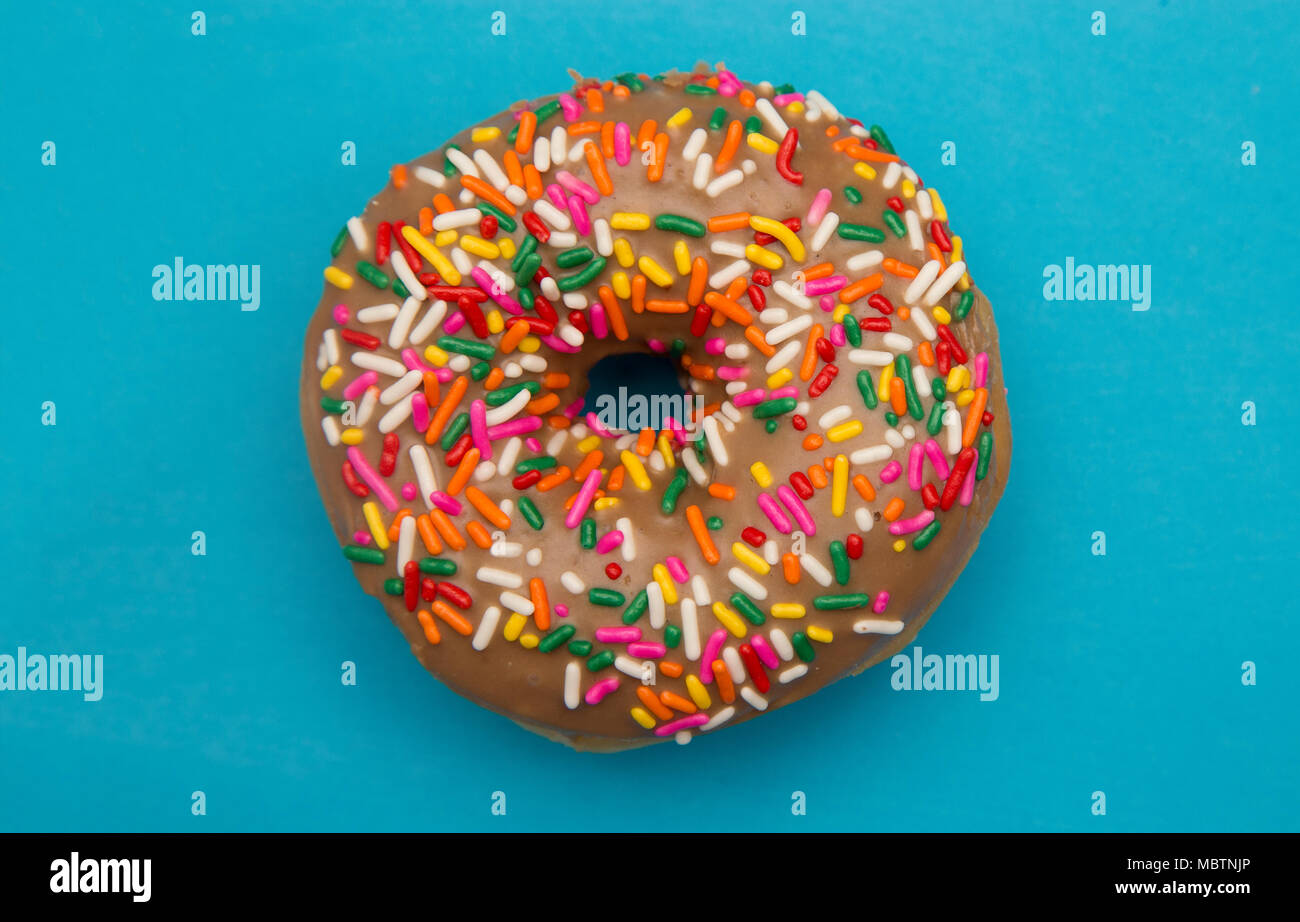 Maple Flavored Sprinkle Donut on a Blue Background Stock Photo - Alamy