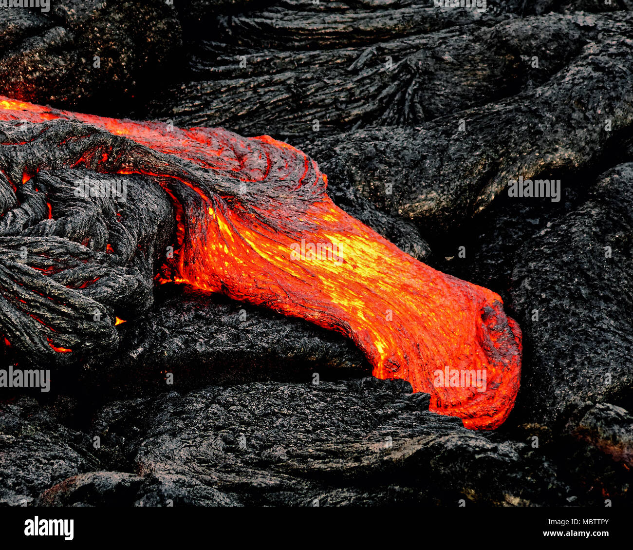 Hot magma escapes from an earth column as part of an active lava flow ...