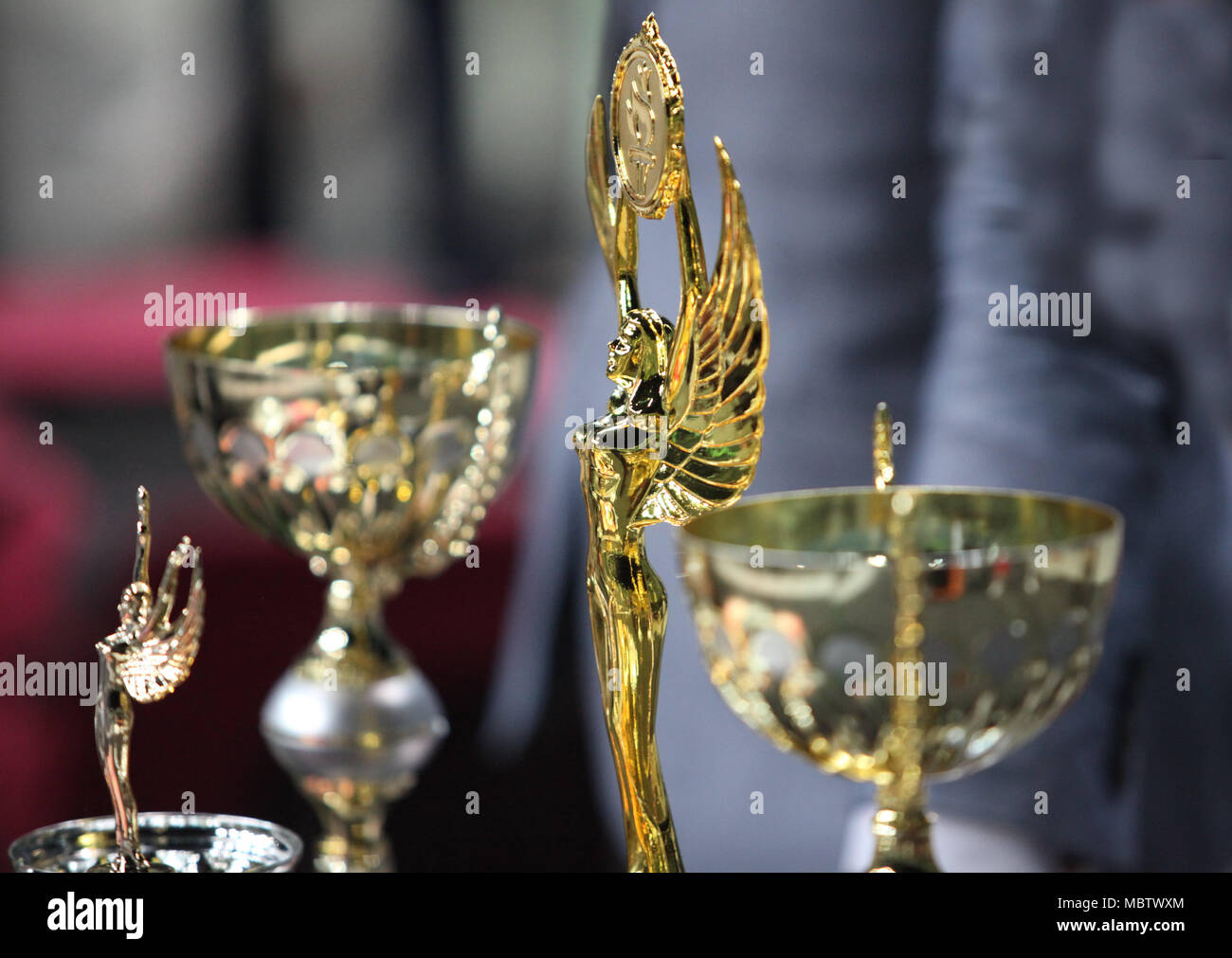 Group of trophies lined up on the shelf Stock Photo - Alamy
