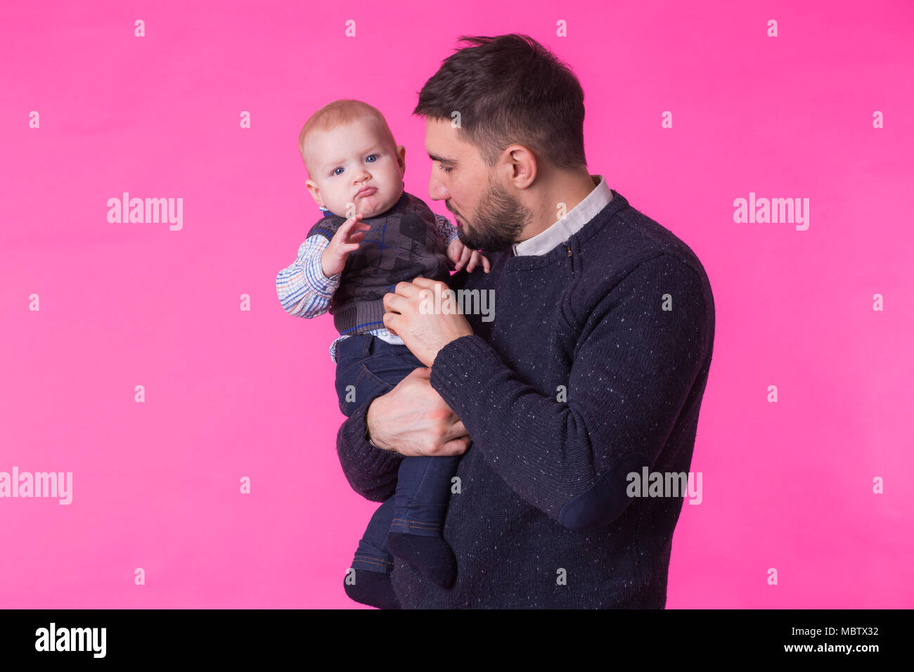 happy father with a baby son isolated on a pink background Stock Photo ...
