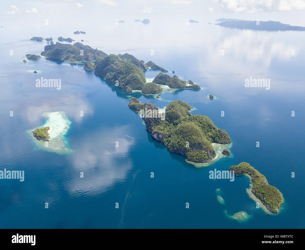 Amazing limestone islands rise from the calm seascape around Misool ...