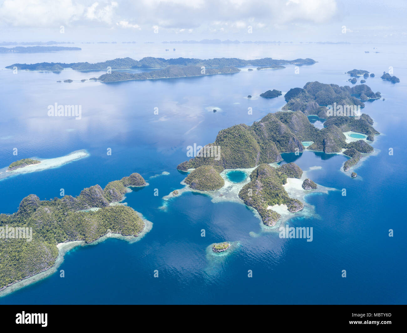 Amazing limestone islands rise from the calm seascape around Misool ...