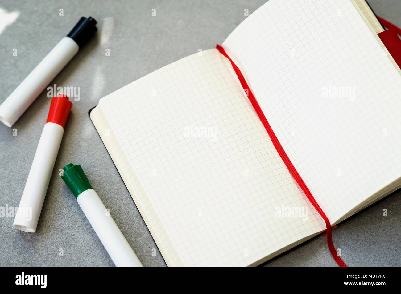 Colored pens, open school notebook, background with copy space for text ...