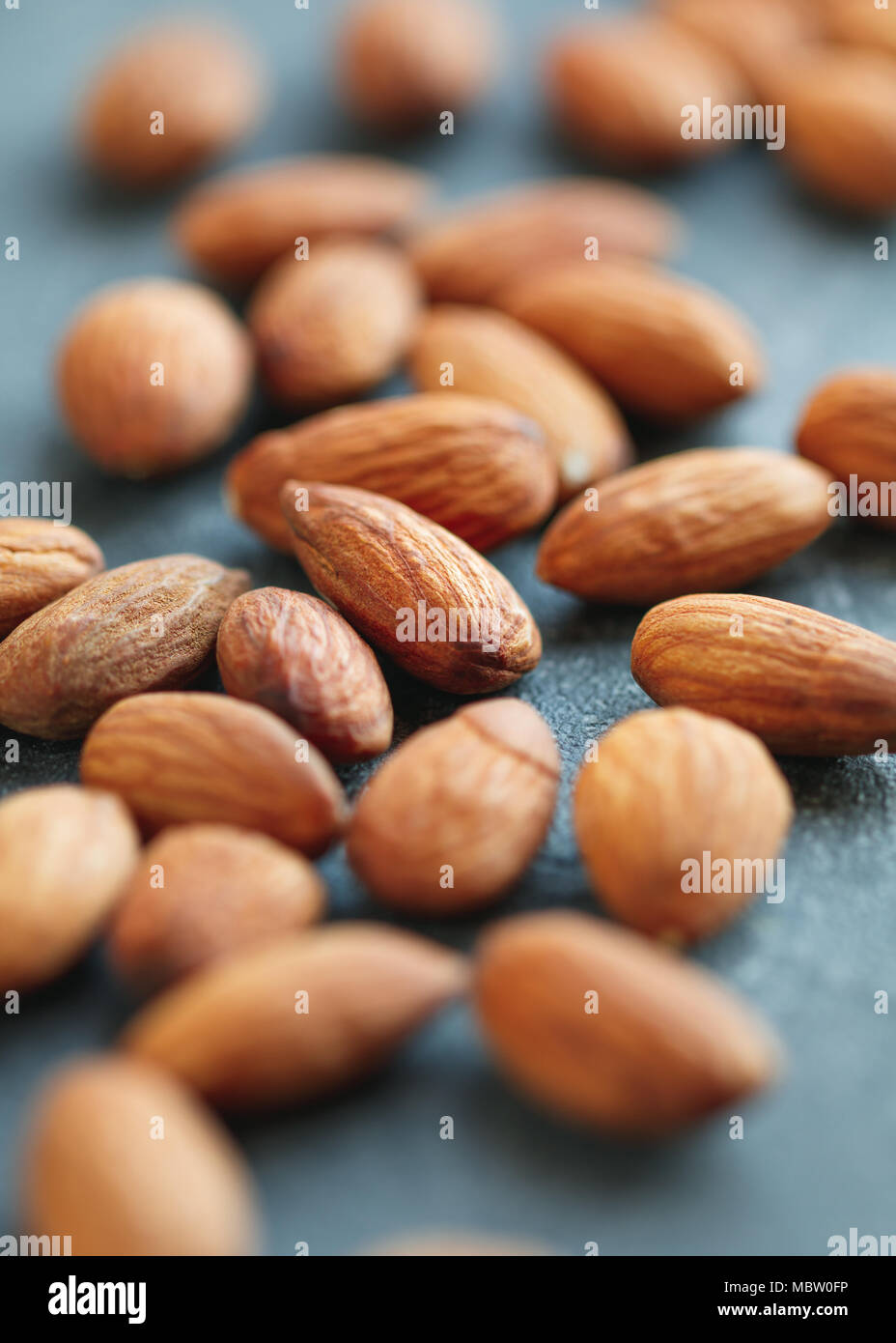 Macro photography of almond nuts over grey background. The concept of ...