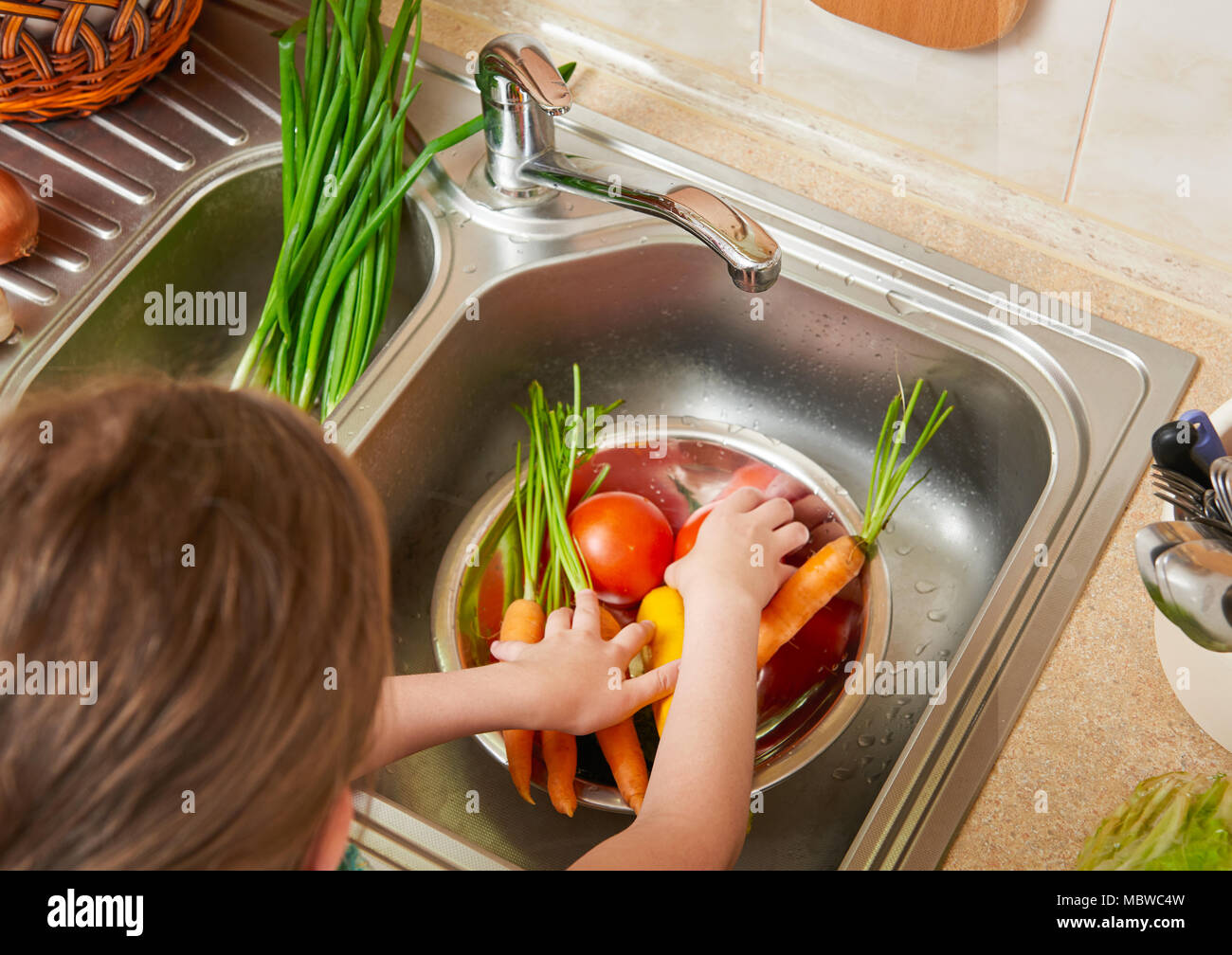 Child wash vegetables sink hi-res stock photography and images - Alamy