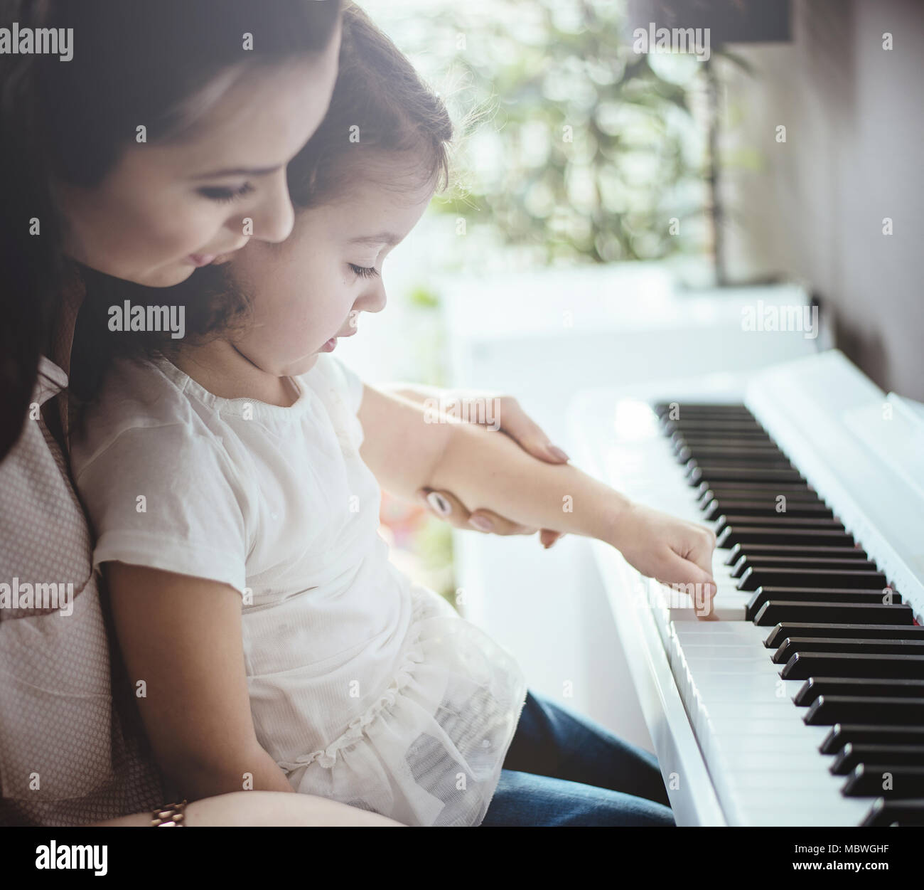 Mom teaching her little daughter piano playing Stock Photo - Alamy Mom teaching her little daughter piano playing Stock Photo - Alamy