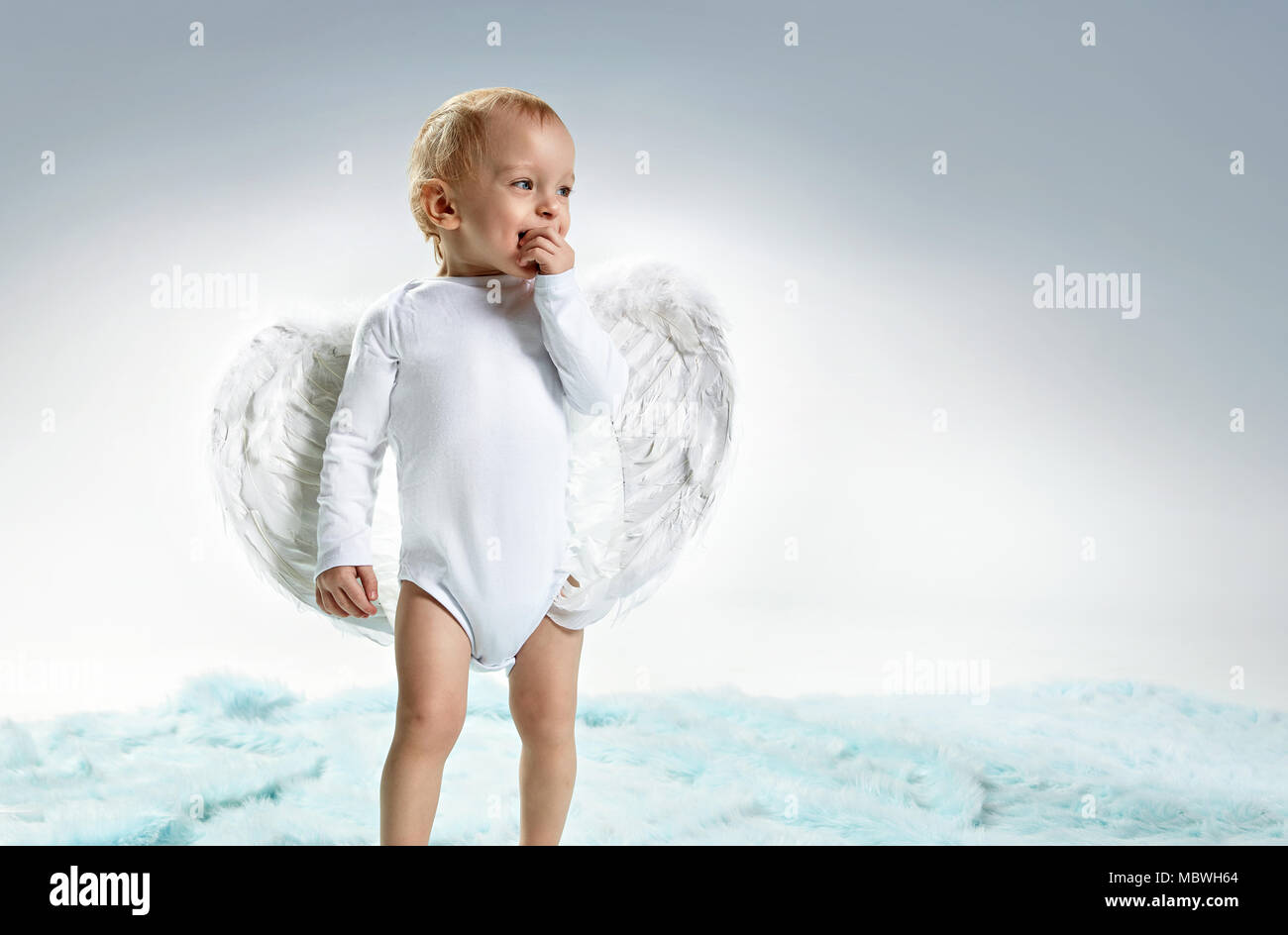 Portrait of a happy little baby angel Stock Photo - Alamy