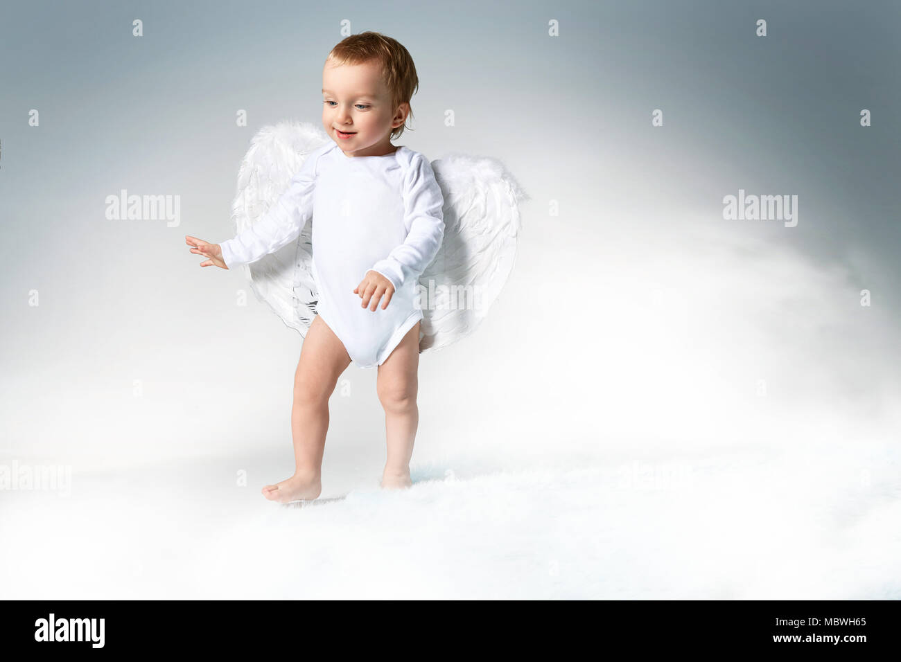 Portrait of a happy little baby angel Stock Photo - Alamy