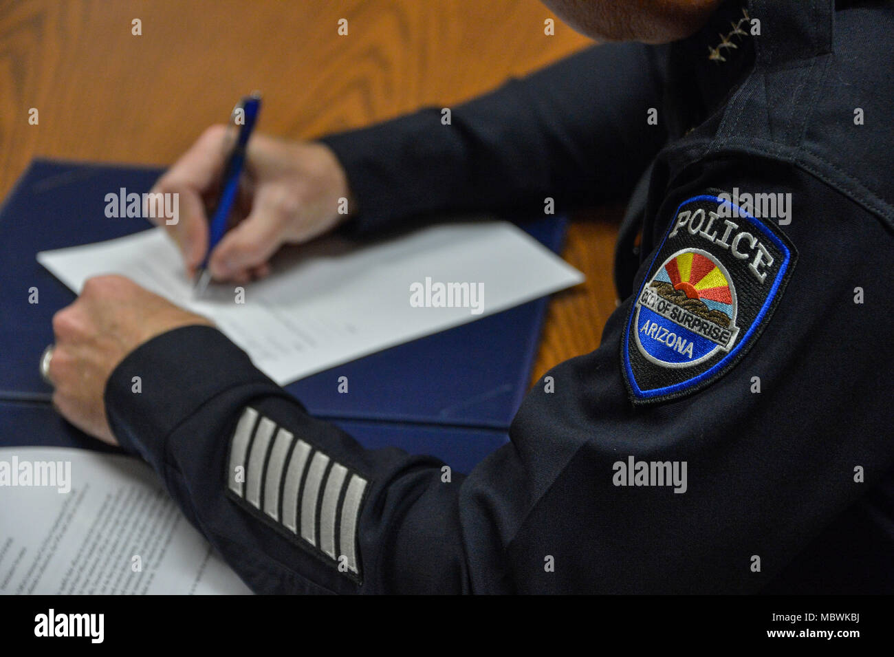 Terry Young, Surprise Police Department police chief, signs the ...