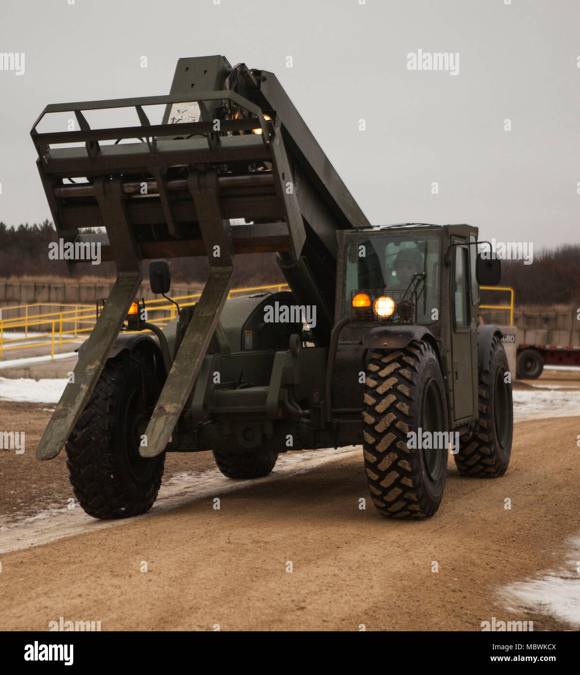 A forklift assigned to Marine Wing Support Squadron 271 is transported ...