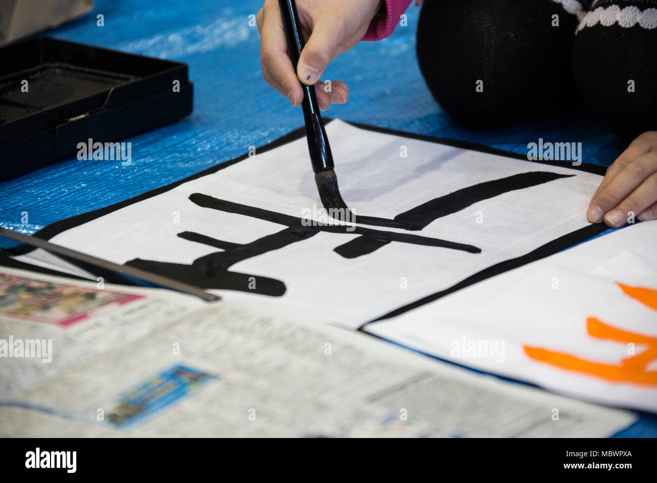 A child paints calligraphy during a U.S.-Japan calligraphy event ...
